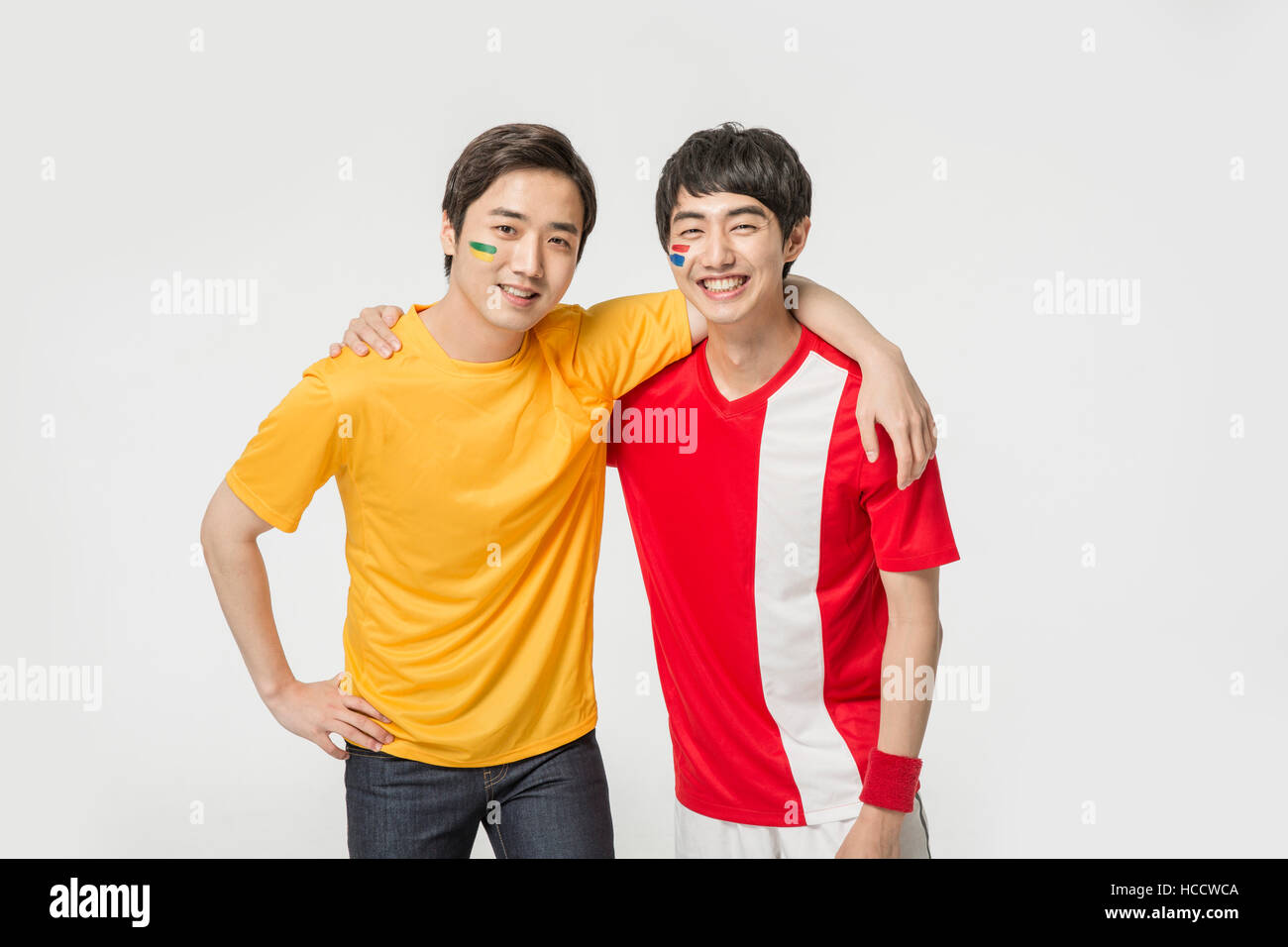 Two young smiling men putting arms on each other's shoulders Stock ...