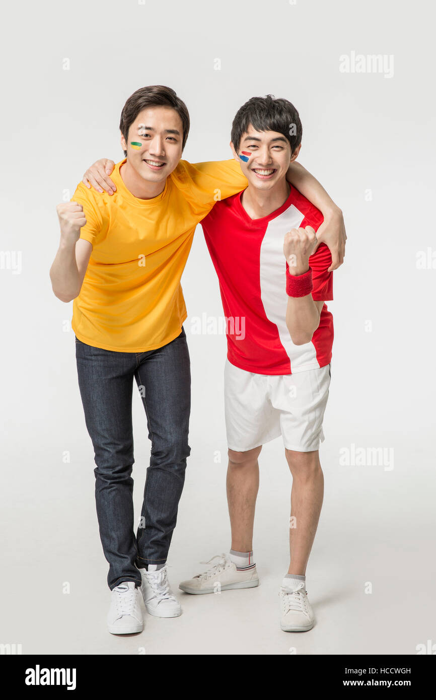 Two smiling men with arms on each other's shoulders cheering Stock ...