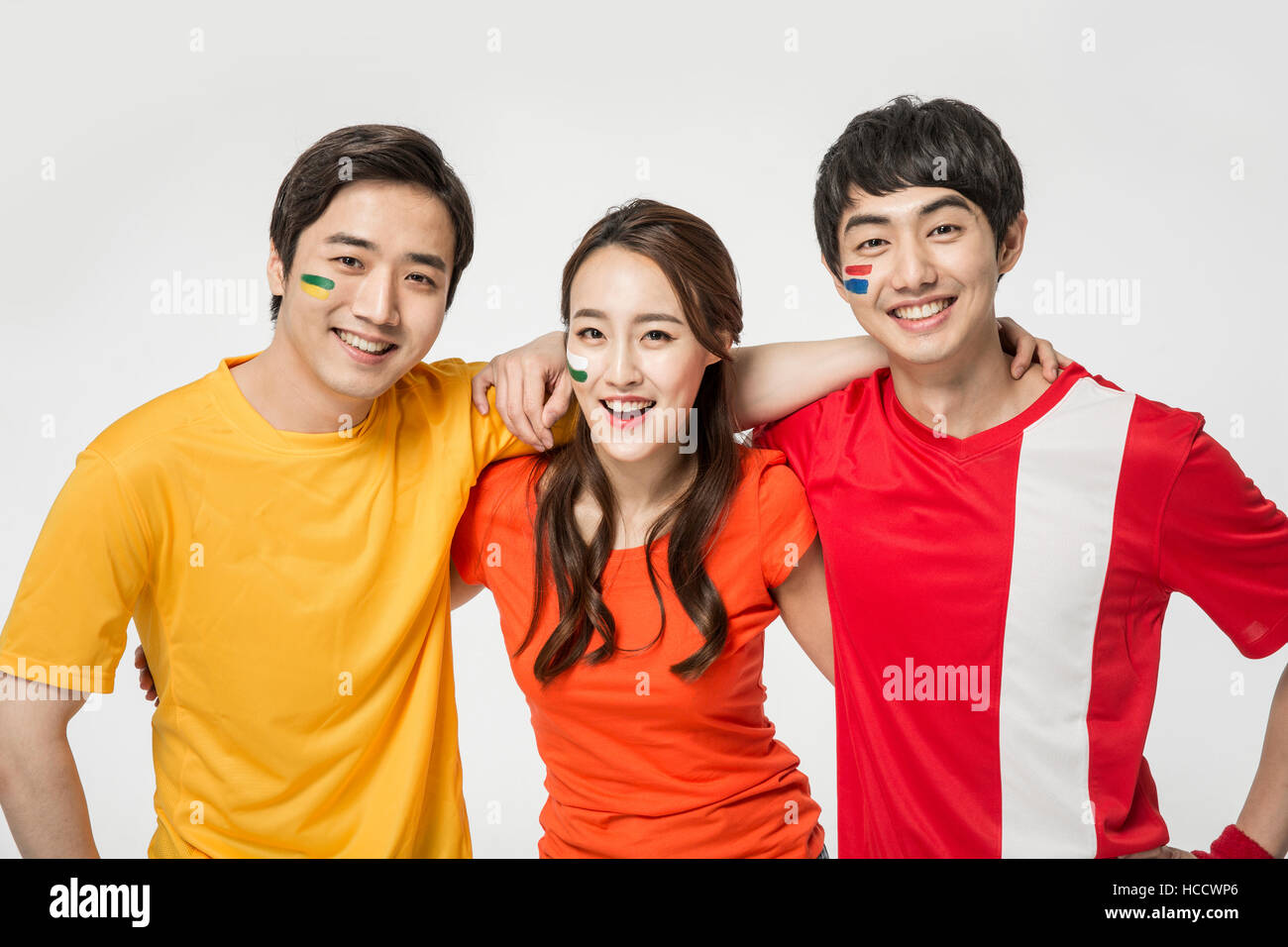 Three young smiling people cheering Stock Photo - Alamy