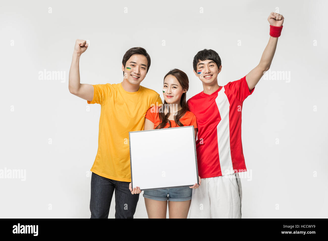 Three young smiling people with board cheering Stock Photo - Alamy