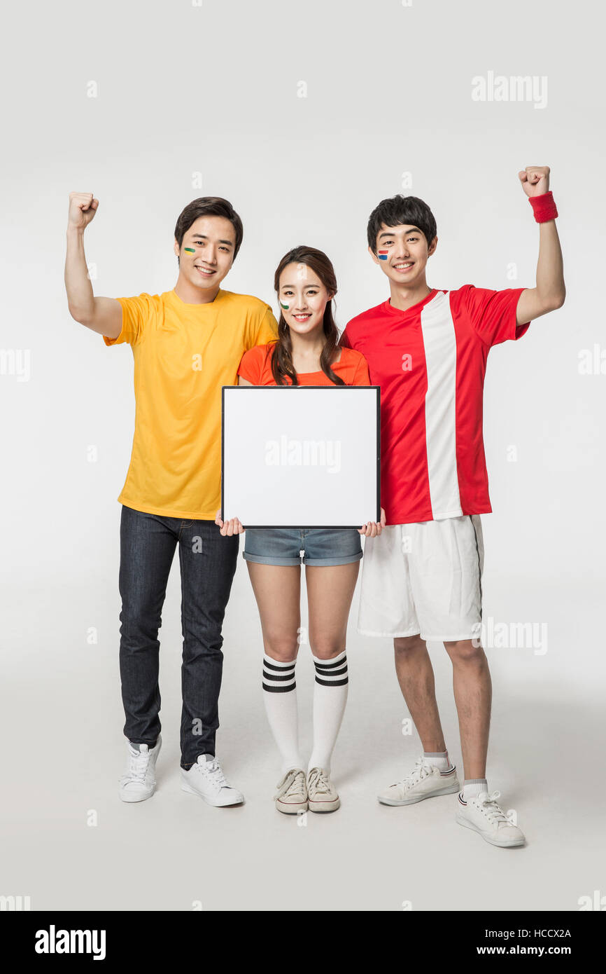 Three young smiling people with board cheering Stock Photo - Alamy