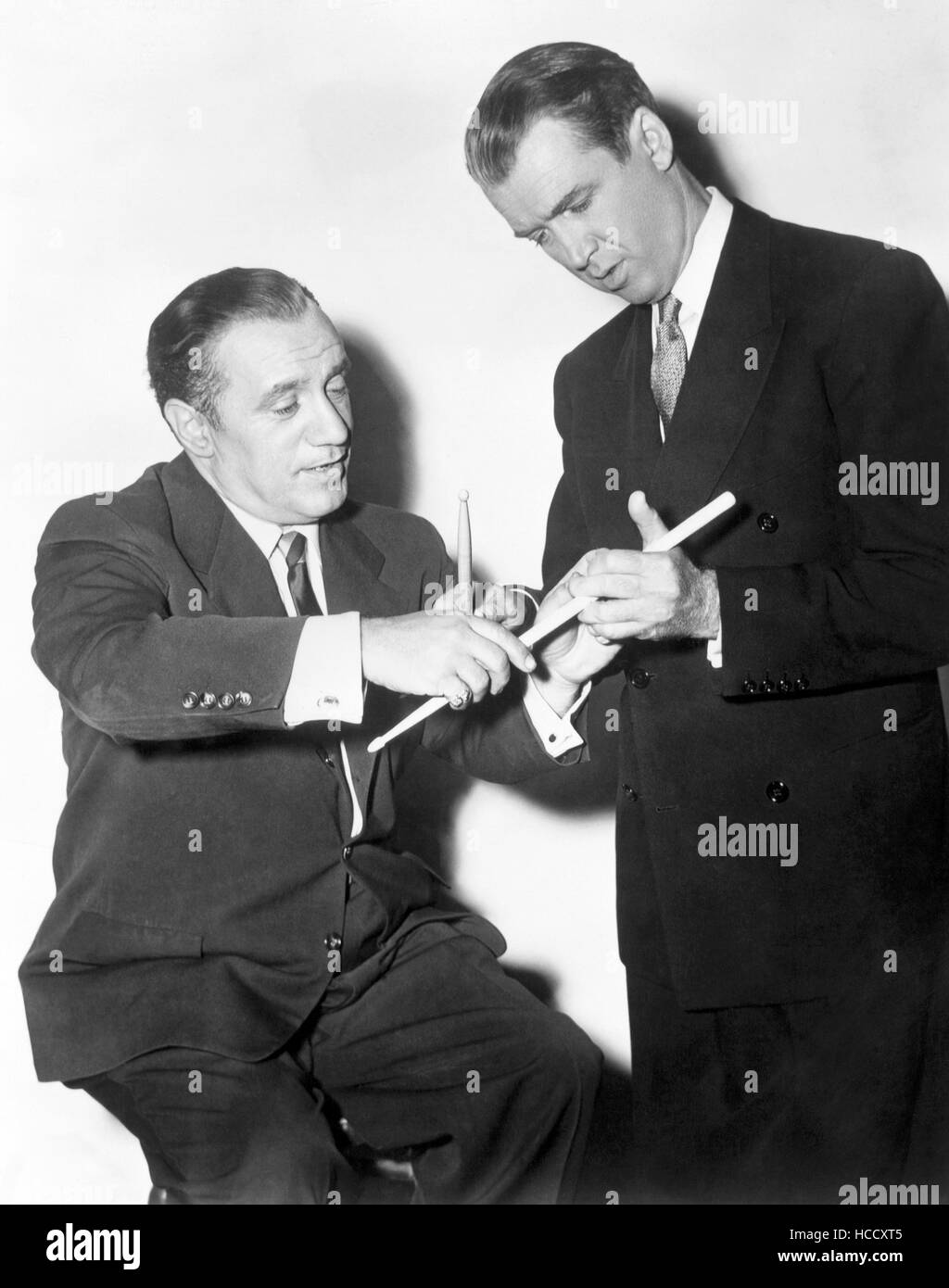 From left: famed bandleader Ben Pollack teaches star James Stewart the ...