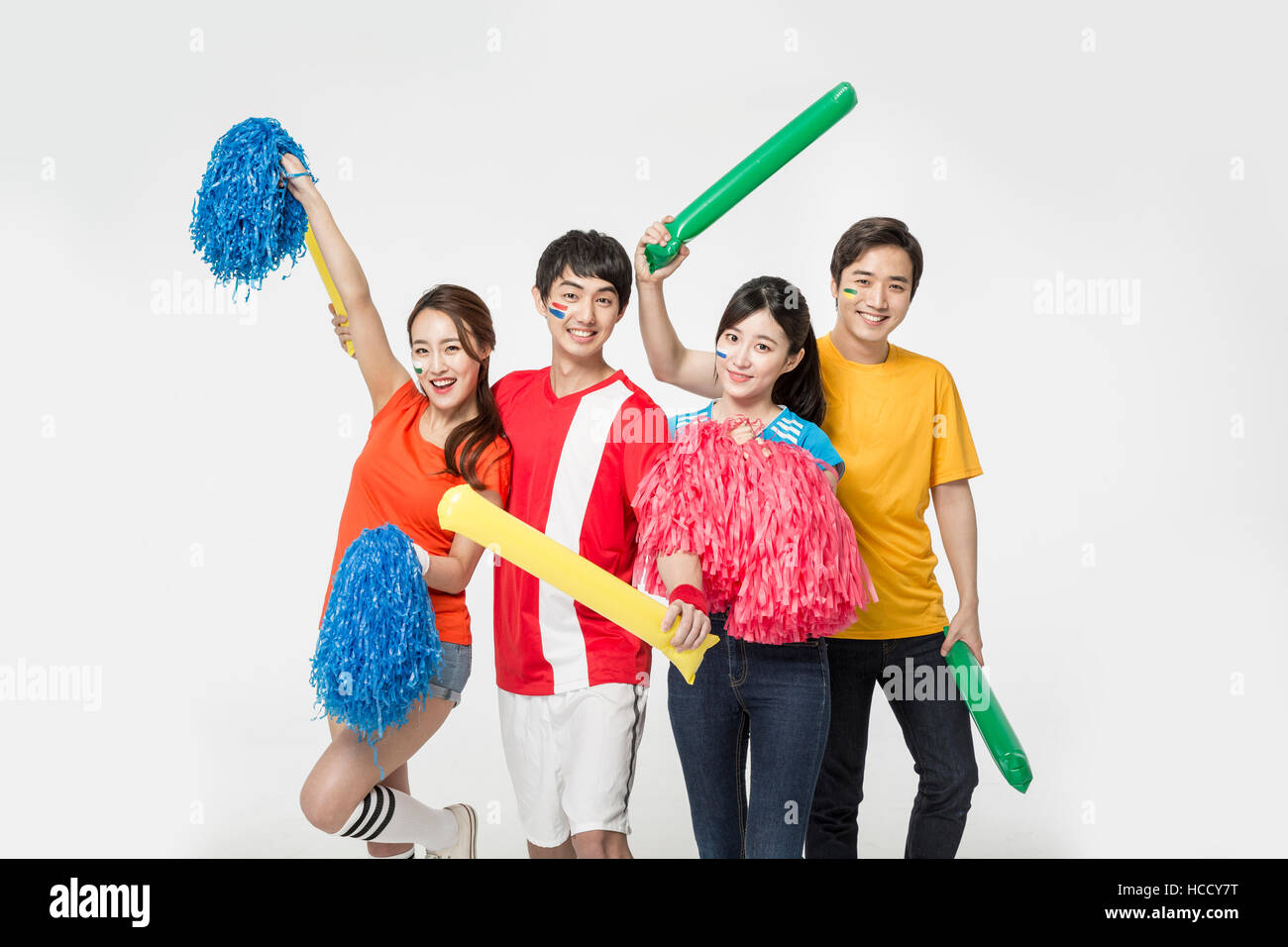 Young smiling people with cheering tools Stock Photo - Alamy
