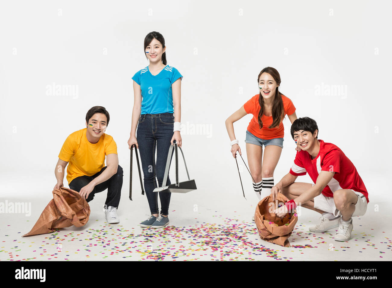 Young smiling cheering team cleaning Stock Photo - Alamy