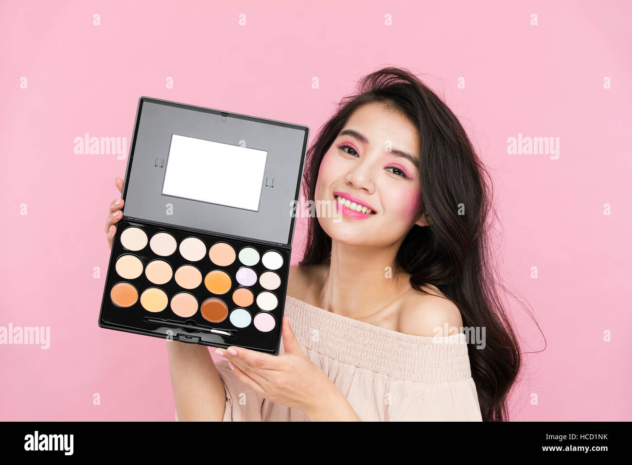 Portrait of young smiling woman showing cosmetic palette Stock Photo ...