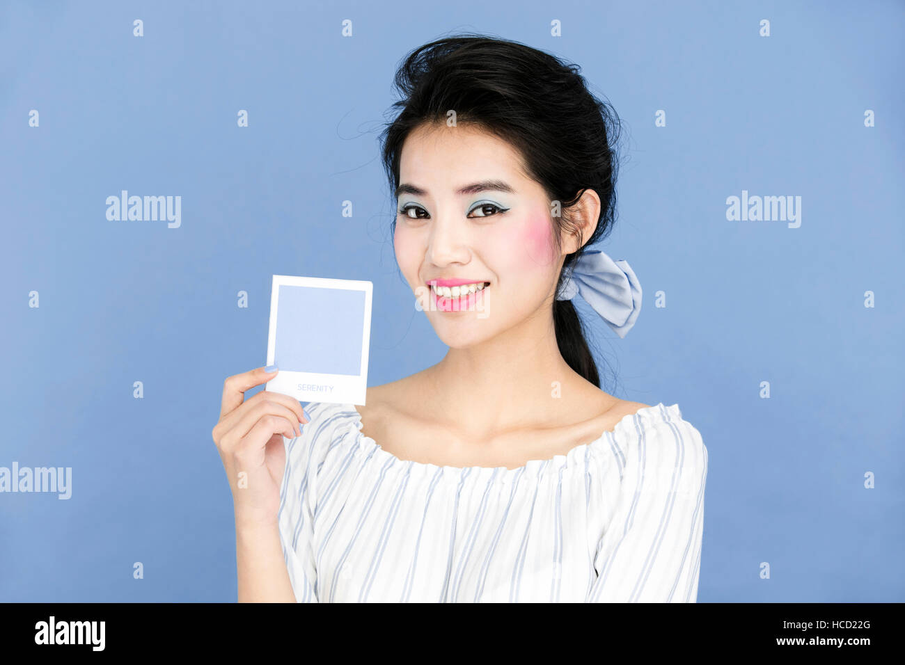 Portrait of young smiling woman with serenity color Stock Photo - Alamy