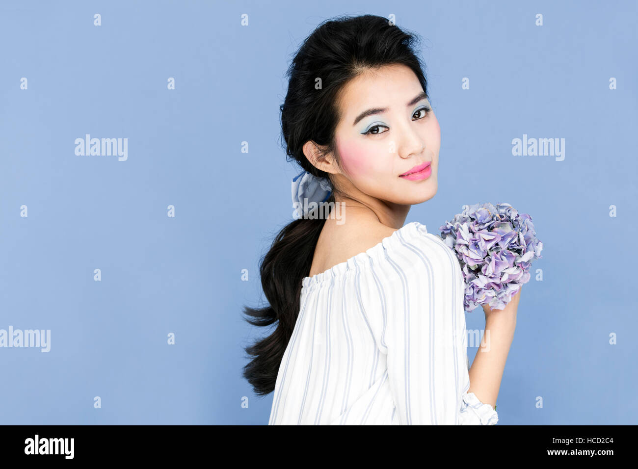 Back portrait of young smiling woman with flowers Stock Photo - Alamy