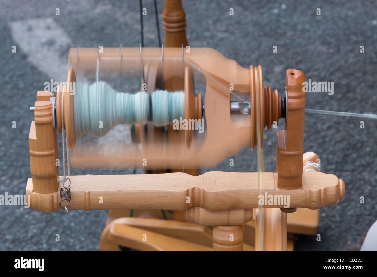 Spinning wool on a spinning wheel Stock Photo - Alamy