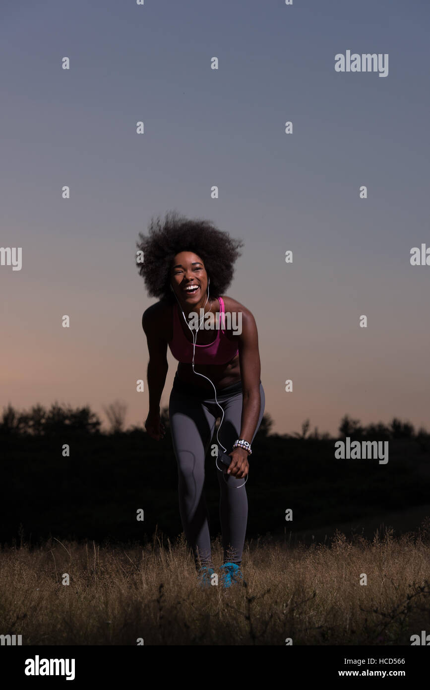 Young healthy black woman is doing stretching exercise relaxing and ...