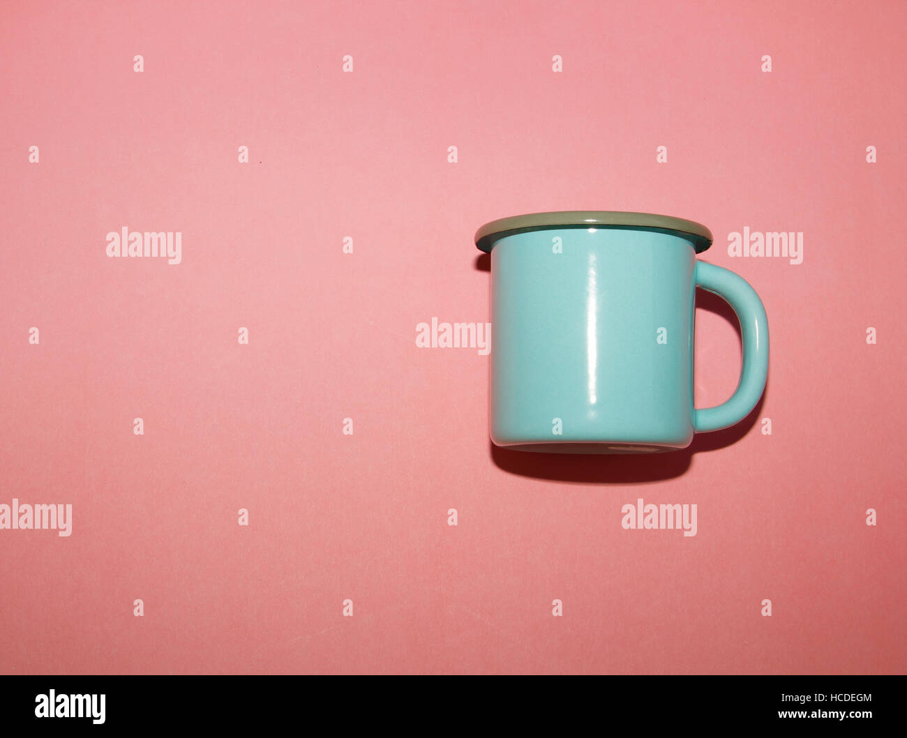 Blue metal cup on the pink background Stock Photo - Alamy