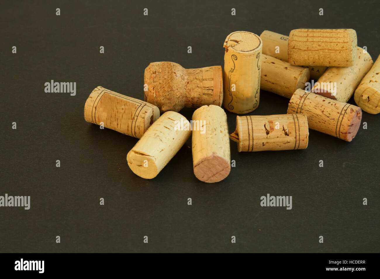 Heap of different corks on black background Stock Photo - Alamy