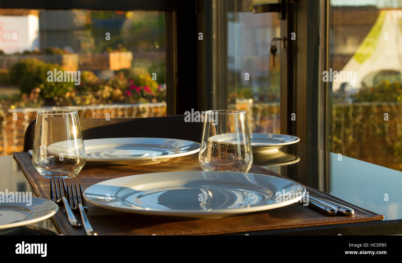 Table in the restaurant served for 2 persons with glasses, plates Stock ...