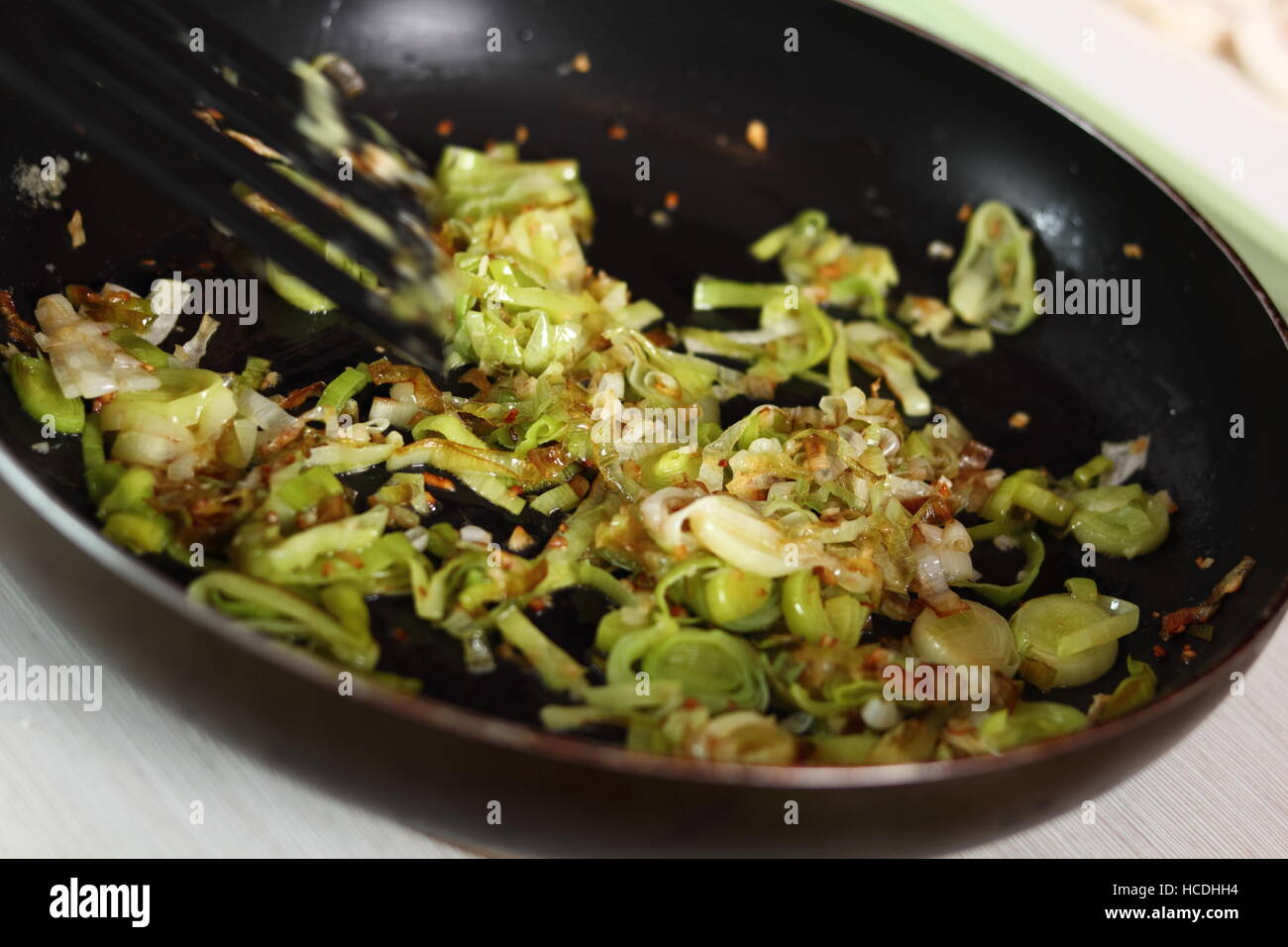Fried leek and garlic in skillet. Making Chicken, Cheese and Leek ...