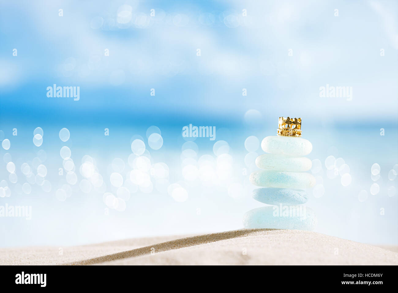 sea glass seaglass with golden crown on glitter seascape background ...