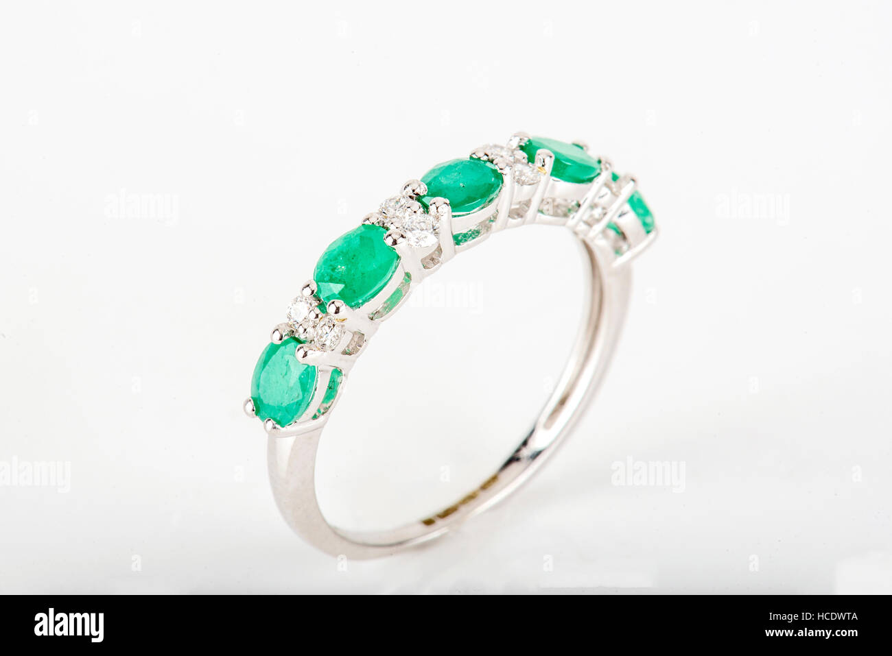Diamond ring with gold and silver and precious stones. Shot standing up ...