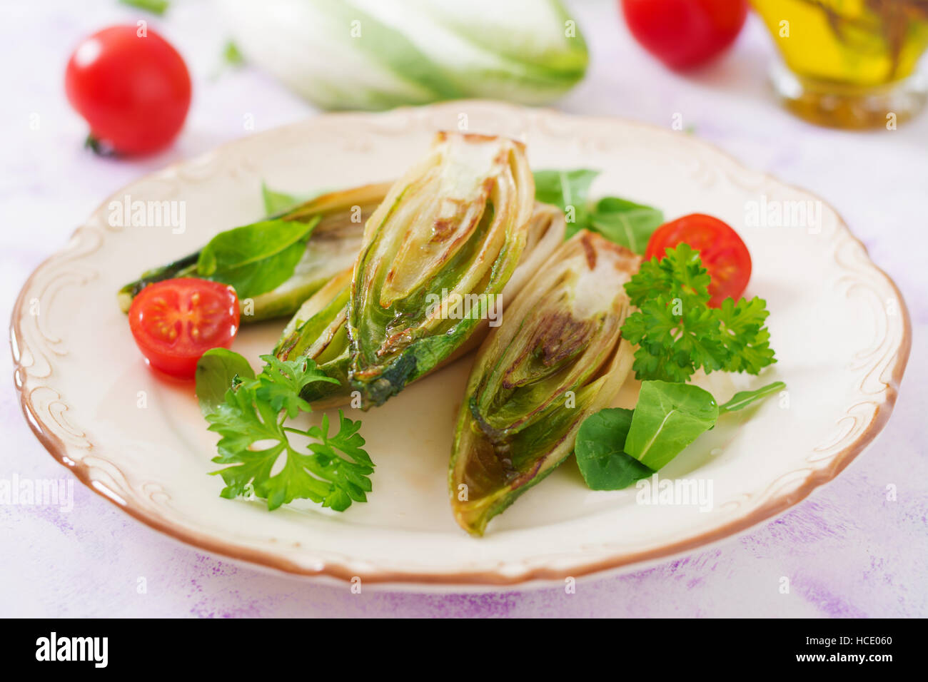 Baked chicory with onions and herbs Stock Photo - Alamy