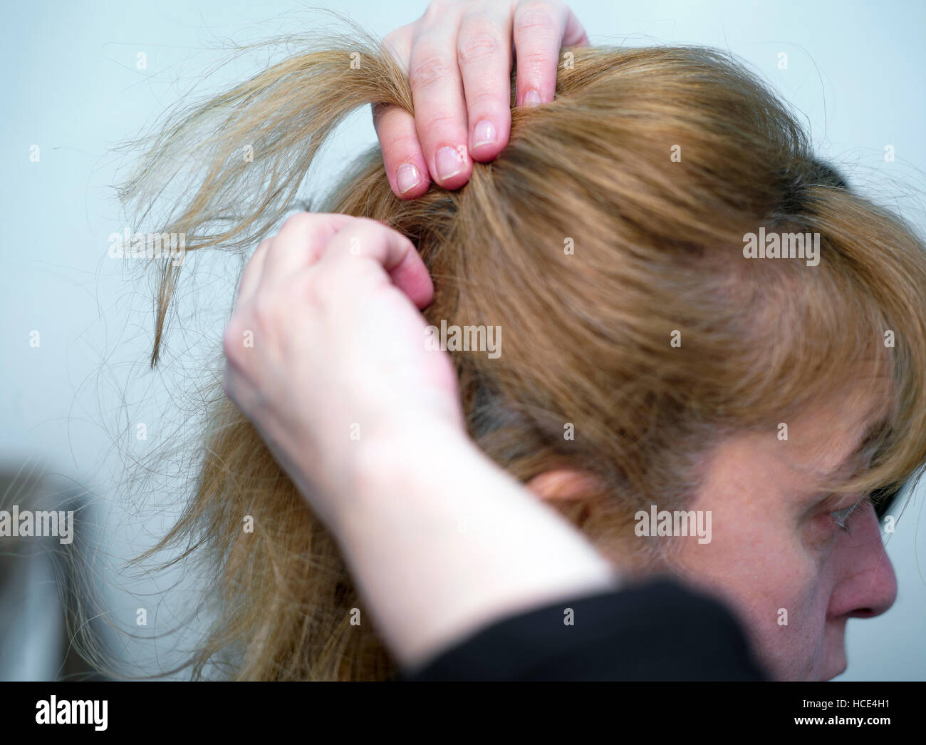Woman Arranging Hair Stock Photo - Alamy