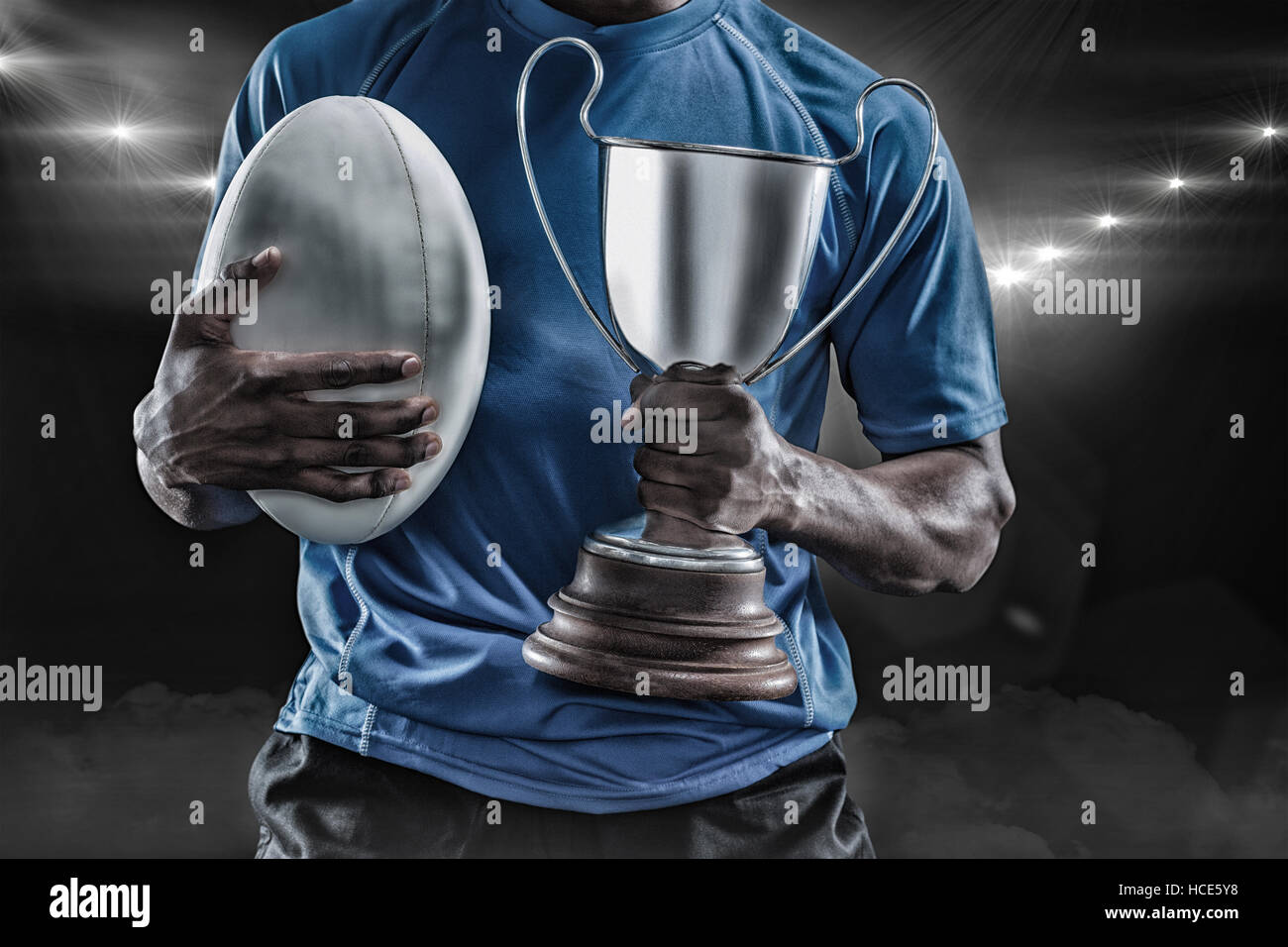 Composite image 3D of mid section of sportsman holding trophy and rugby ...