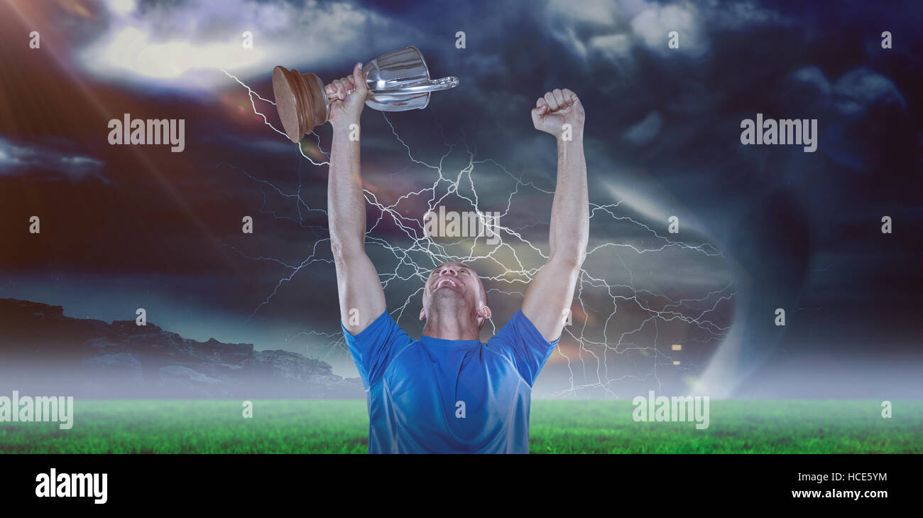 Composite image of happy rugby player holding trophy 3D Stock Photo - Alamy