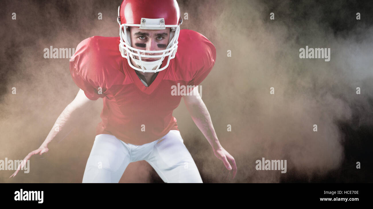 Composite image of a serious american football player taking his helmet ...