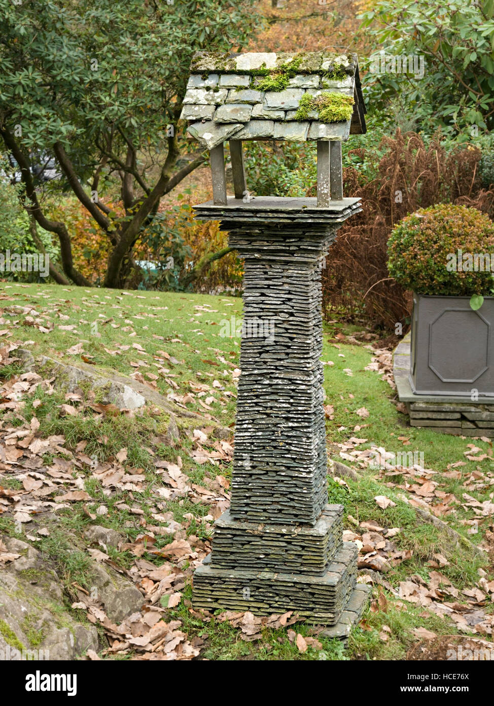 Slate stone bird table in garden with lawn Stock Photo - Alamy