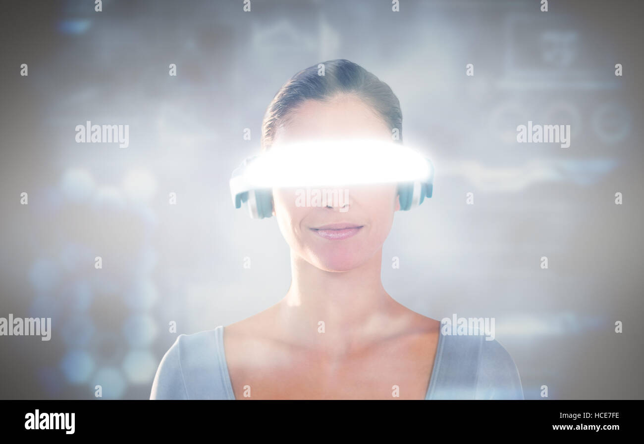 Composite image of beautiful young woman using virtual video glasses ...