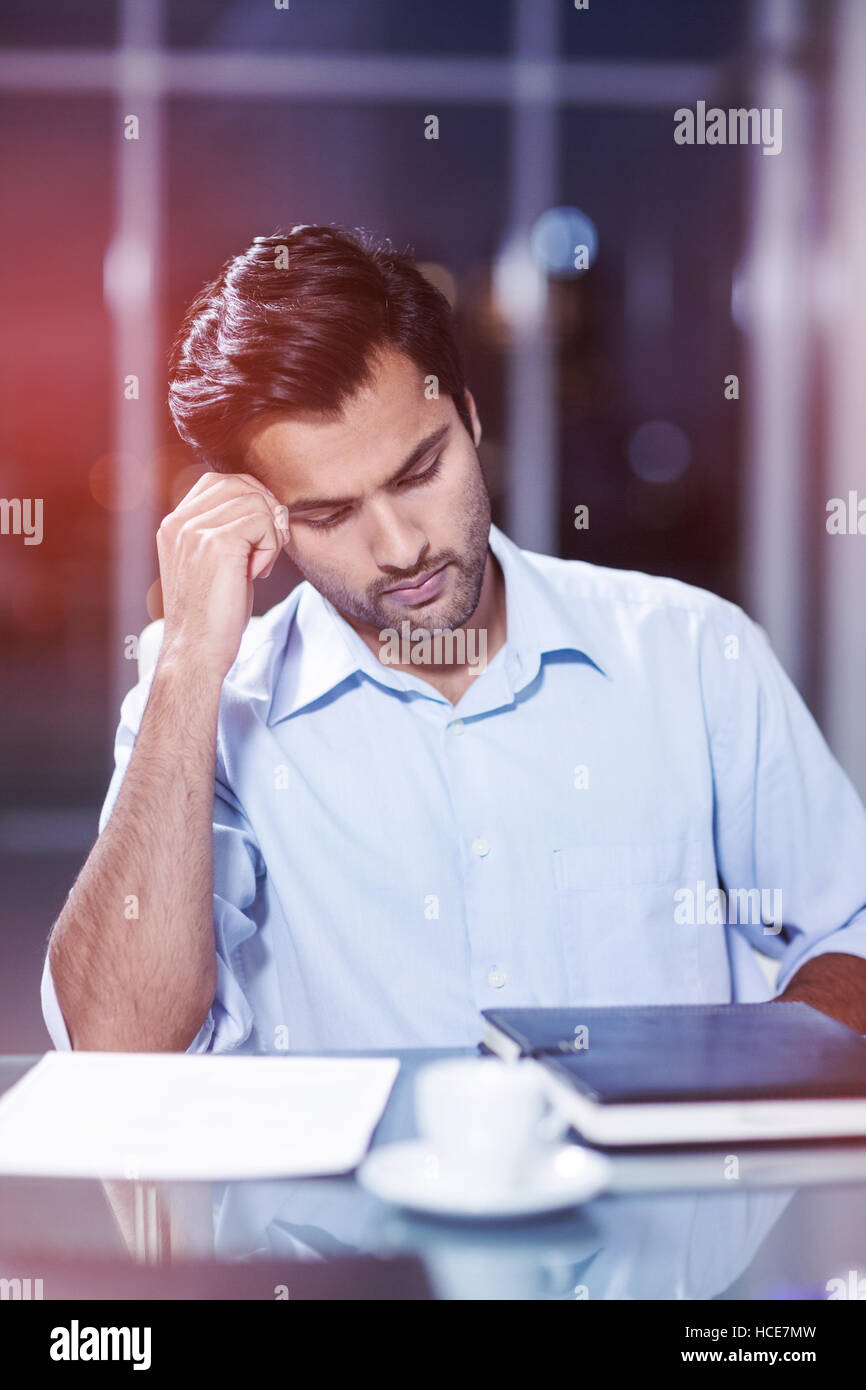 Sad man sitting at his desk Stock Photo - Alamy