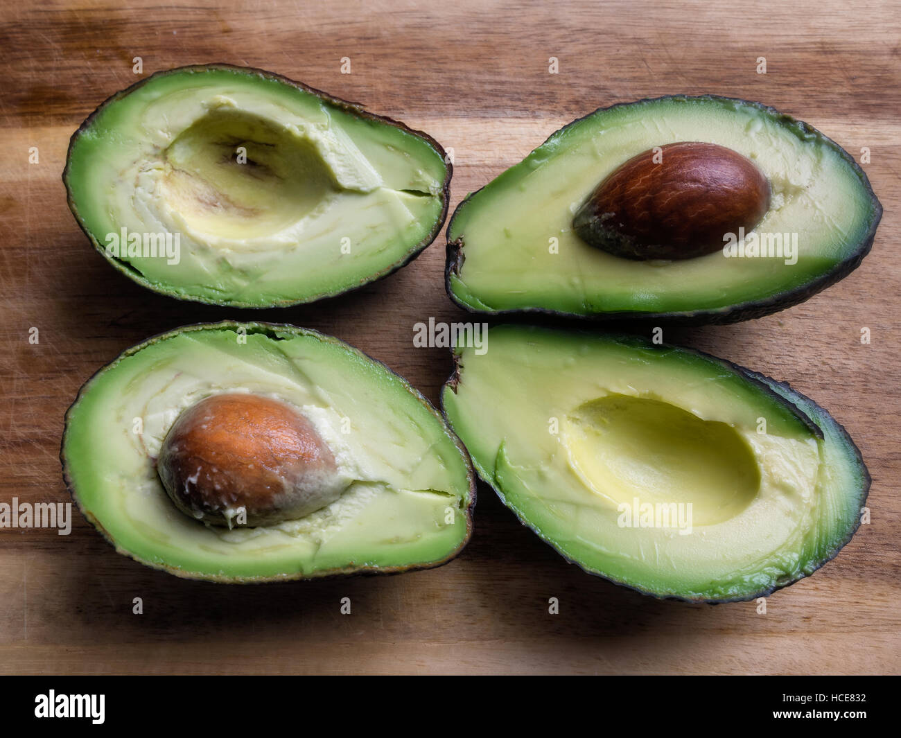 Two delicious ripe avocados cut into halves Stock Photo - Alamy