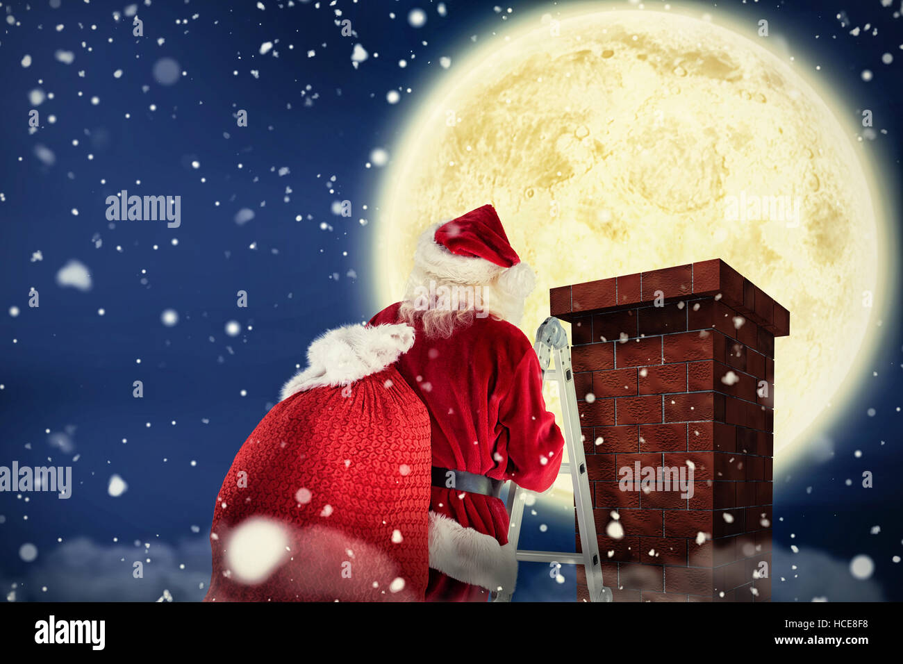 Composite image of santa steps up a ladder Stock Photo - Alamy