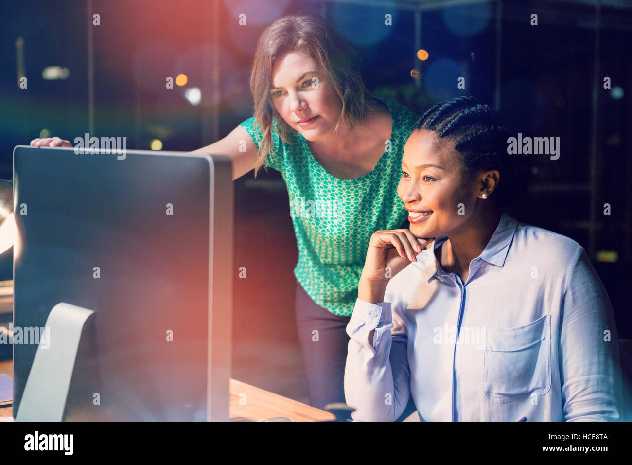 Women looking at computer Stock Photo - Alamy