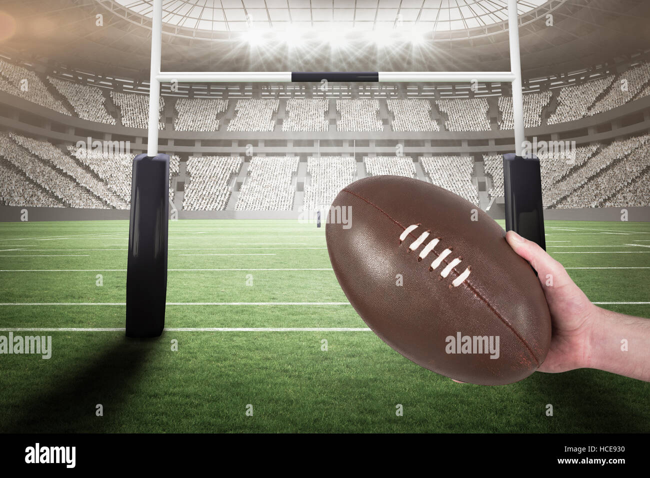 Composite image of rugby player handing a rugby ball 3D Stock Photo - Alamy