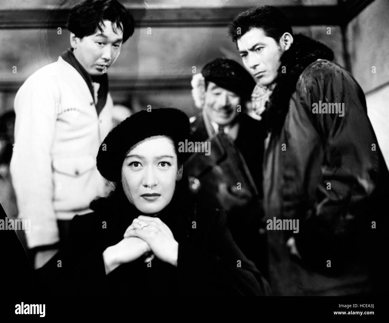 THE IDIOT, (aka HAKUCHI), foreground from left: Minoru Chiaki, Setsuko Hara, Toshiro Mifune ...