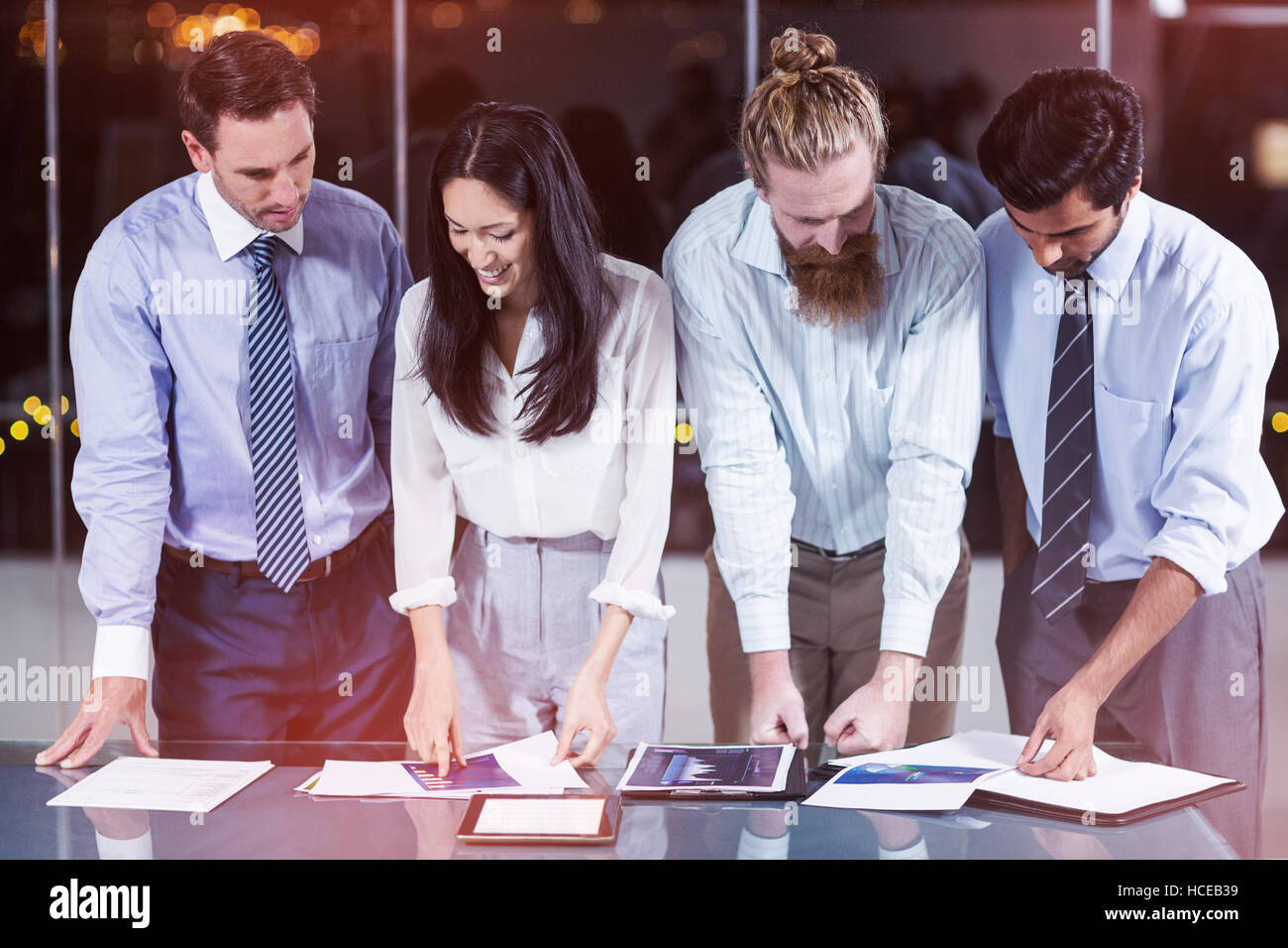 Businesspeople looking at document Stock Photo - Alamy