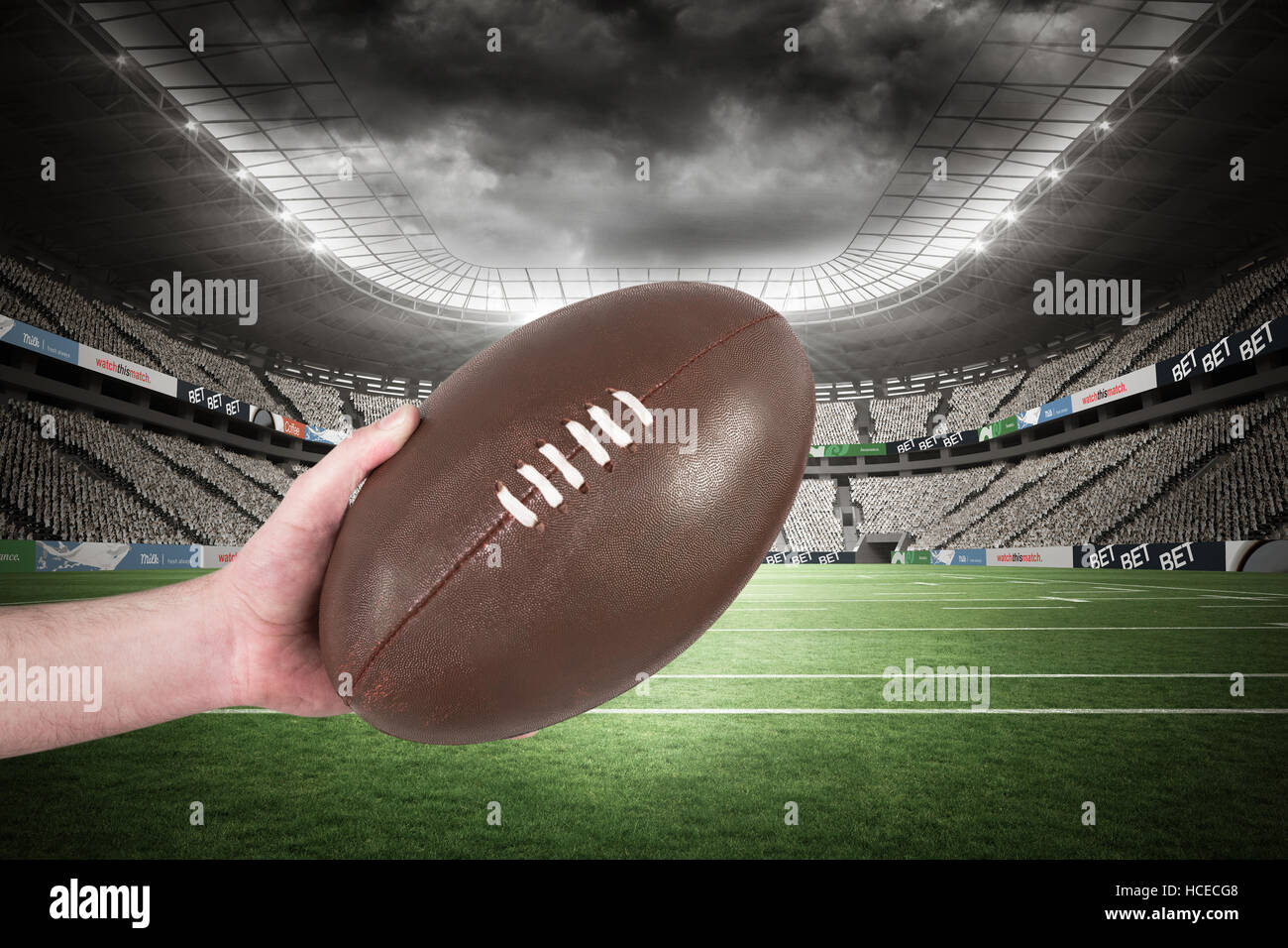Composite image of rugby player handing a rugby ball 3D Stock Photo - Alamy