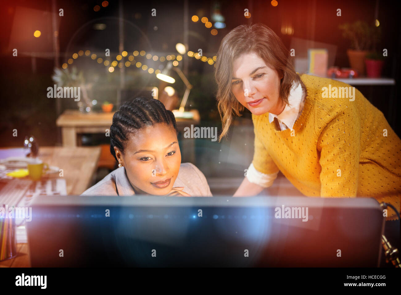Women looking at computer Stock Photo - Alamy