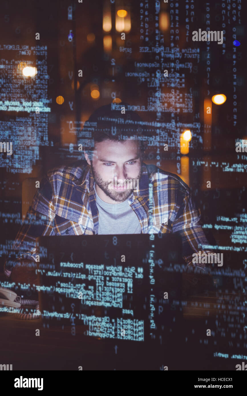 Businessman using laptop at night Stock Photo - Alamy