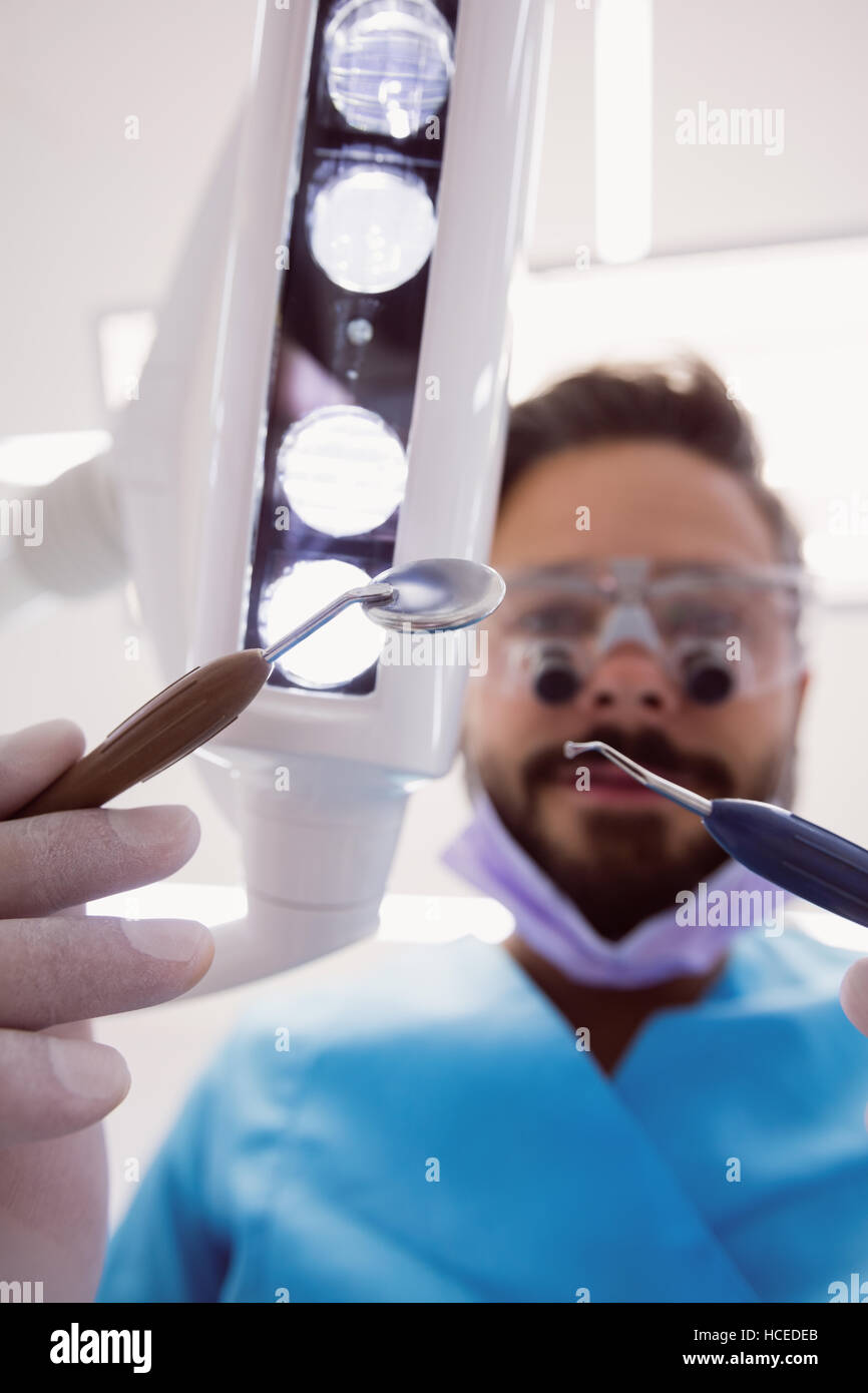 Dentist holding dental tools Stock Photo - Alamy