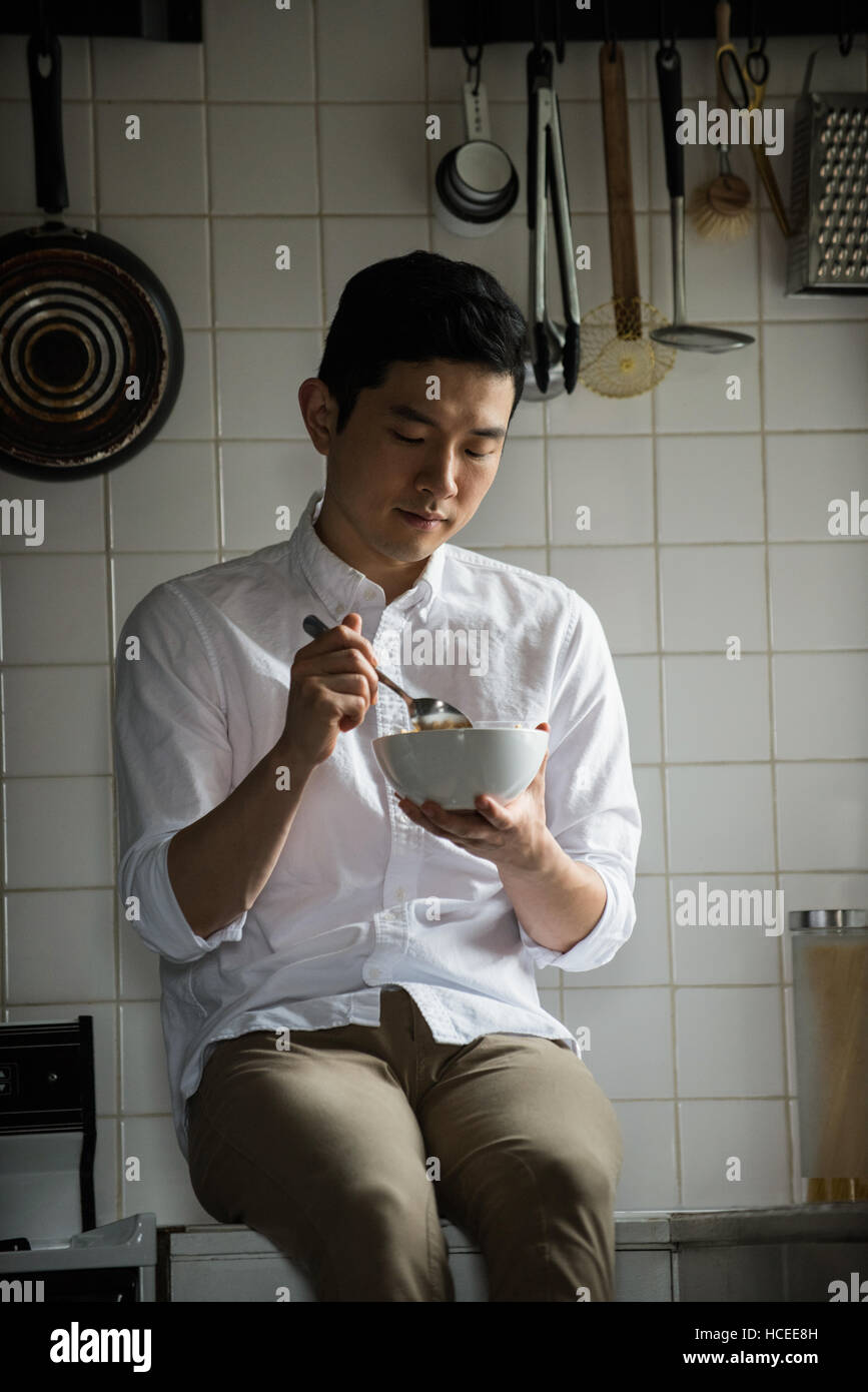 Man having breakfast in kitchen Stock Photo - Alamy