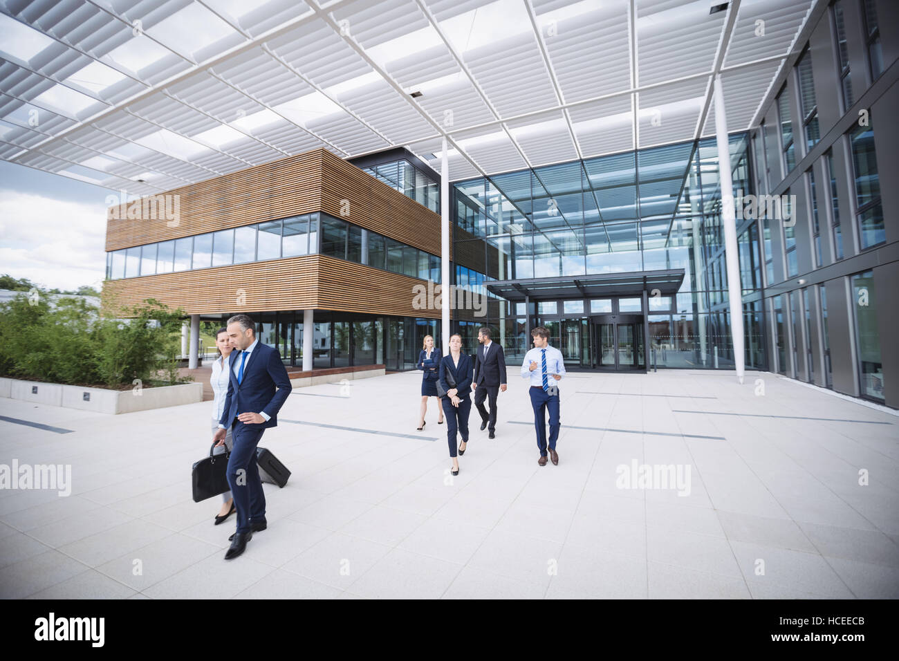 Business people walking outside office building Stock Photo - Alamy