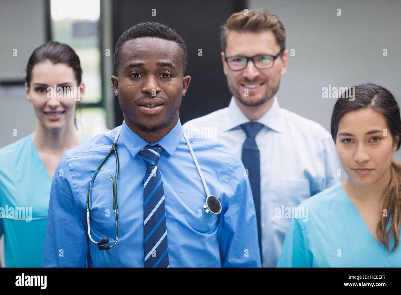 Smiling medical team standing together in hospital corridor Stock Photo - Alamy