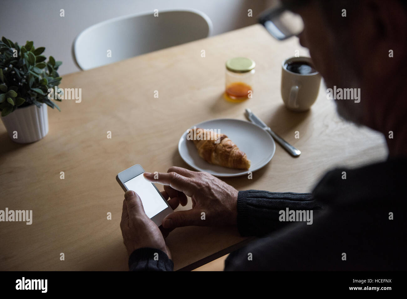 Man using mobilephone while in living room Stock Photo - Alamy