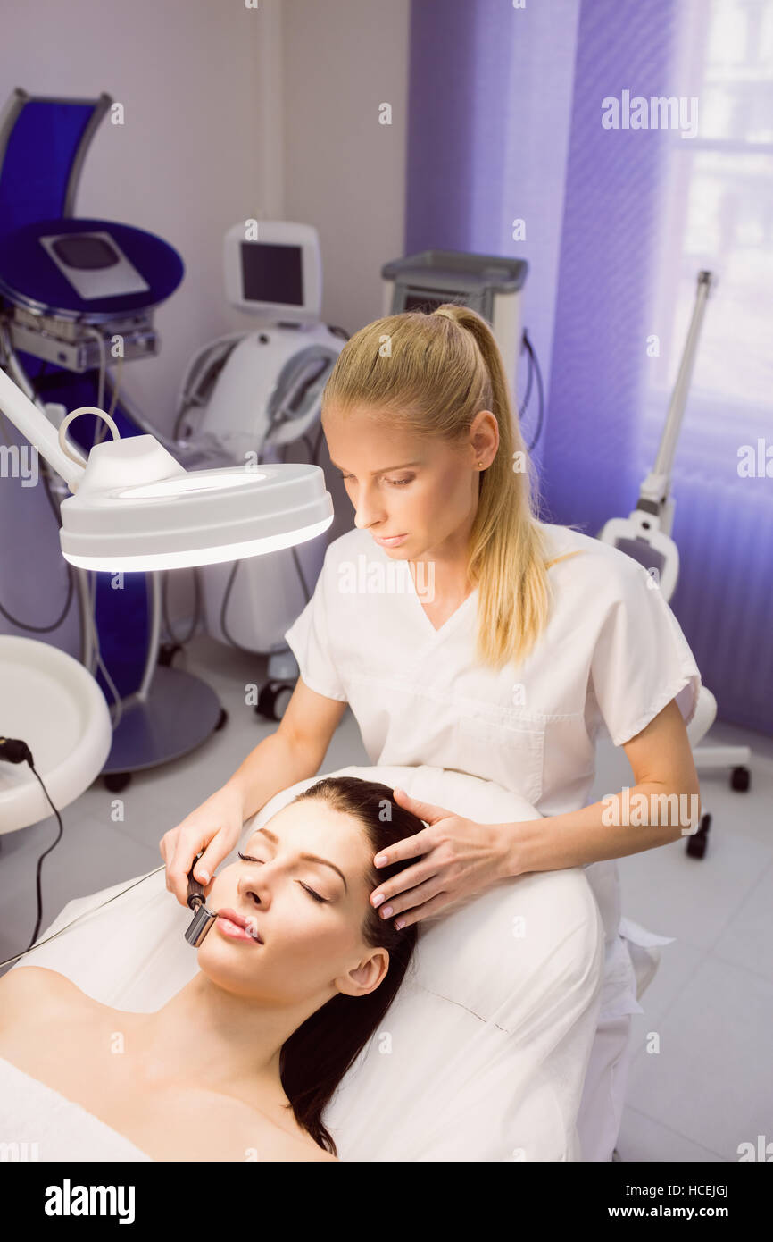 Dermatologist performing laser hair removal on patient Stock Photo - Alamy