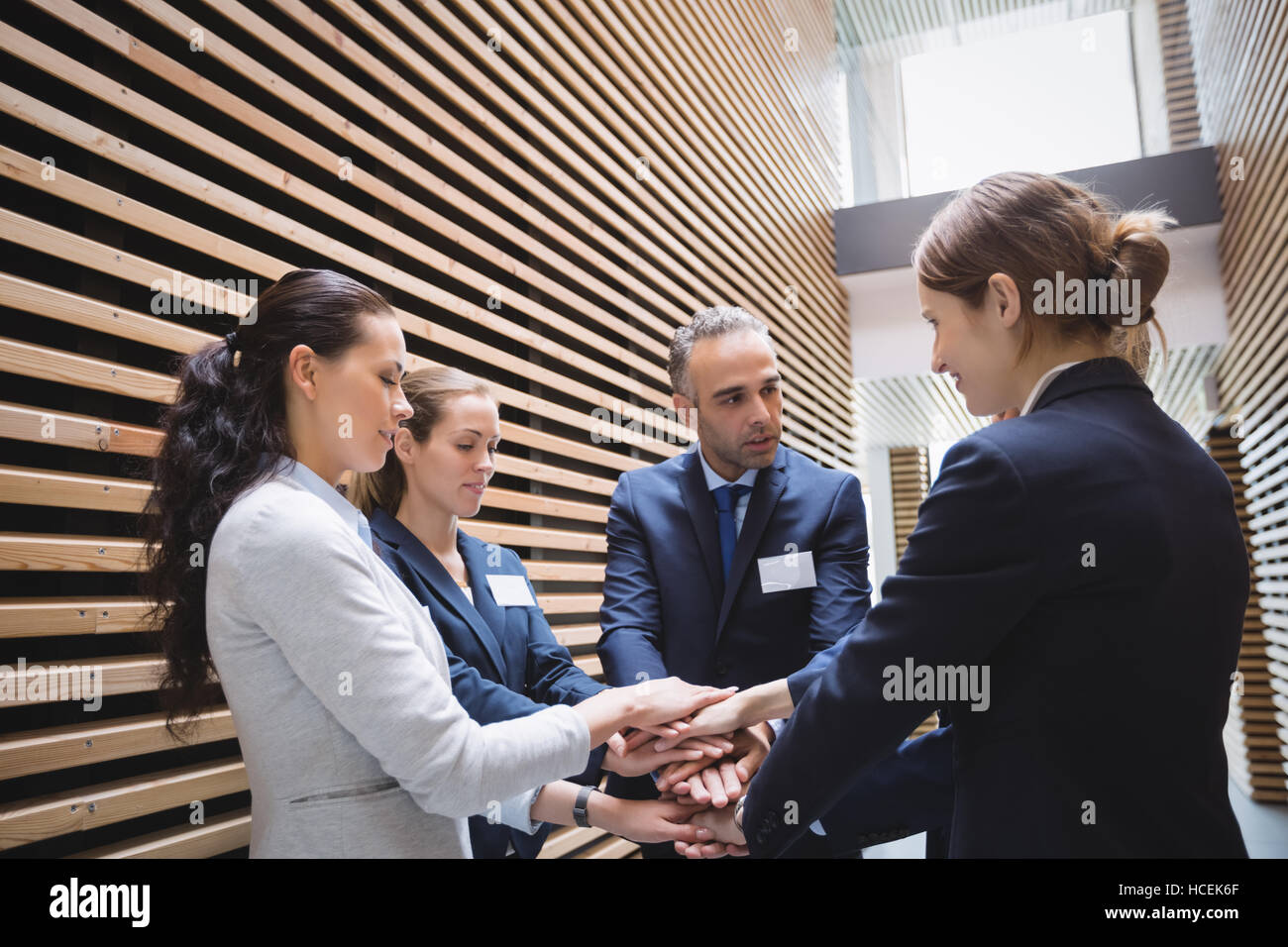 Businesspeople stacking hands together Stock Photo - Alamy