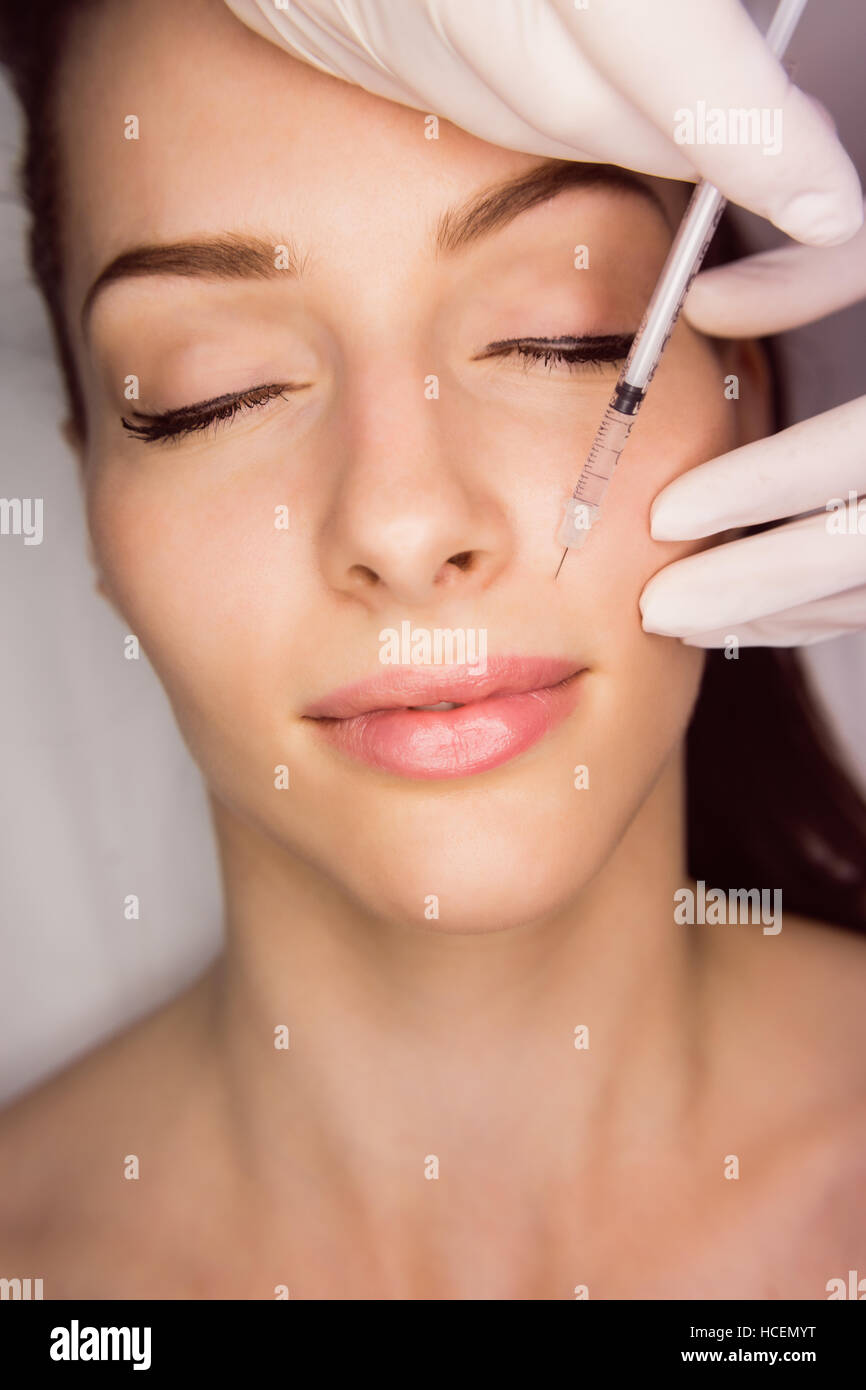 Female patient receiving an injection on her face Stock Photo - Alamy