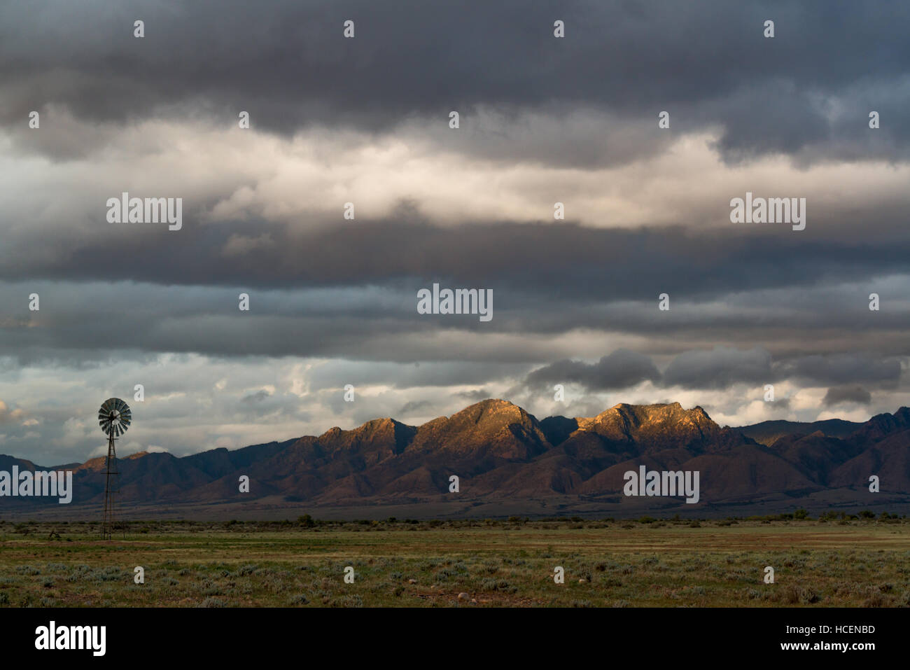 thunderous clouds breaking with sunlight lighting the side of the ...