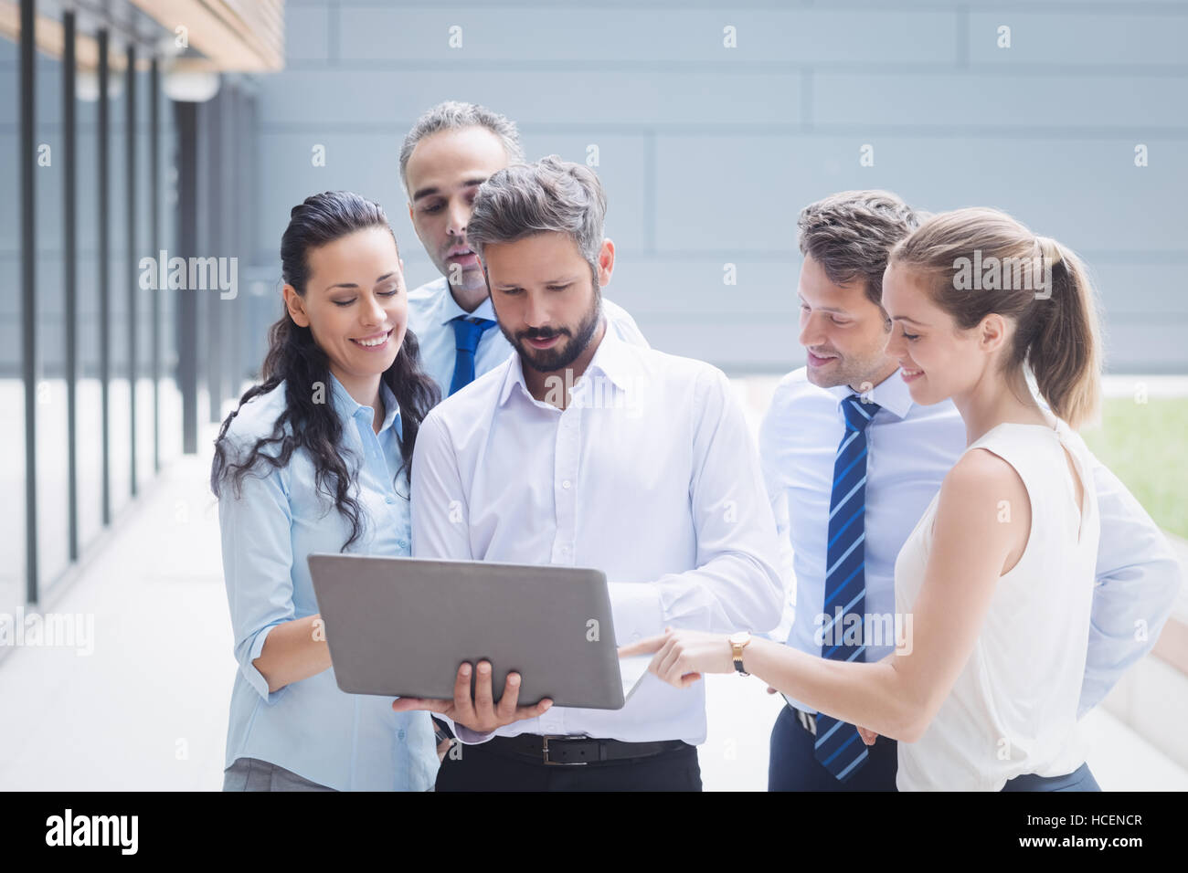 Businesspeople discussing over laptop Stock Photo - Alamy Businesspeople discussing over laptop Stock Photo - Alamy