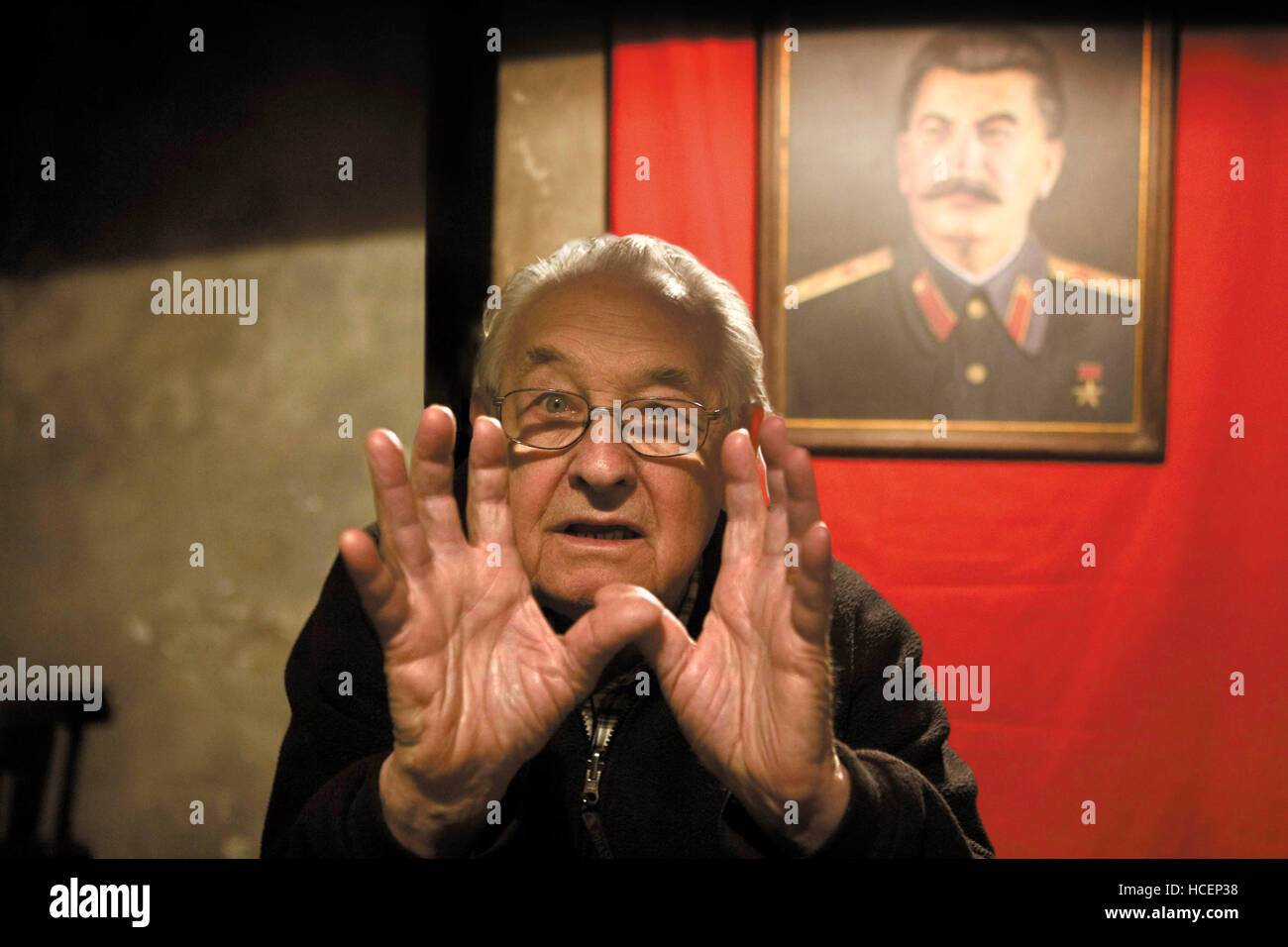 KATYN, director Andrzej Wajda, on set, with a portrait of Josef Stalin ...