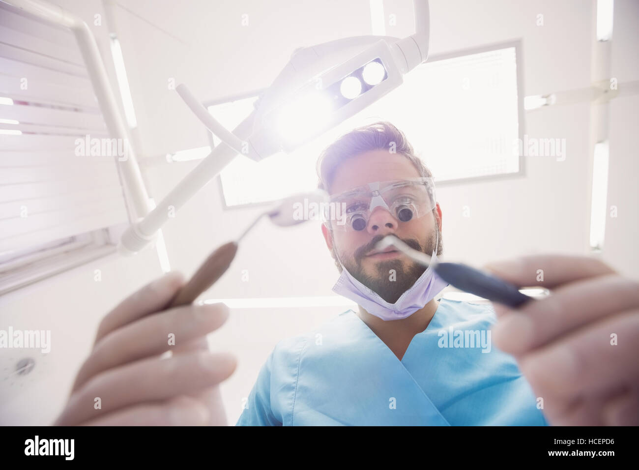 Dentist holding dental tools Stock Photo - Alamy