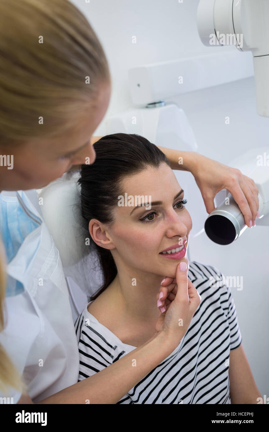 Dentist taking a female patients tooth x-ray Stock Photo - Alamy