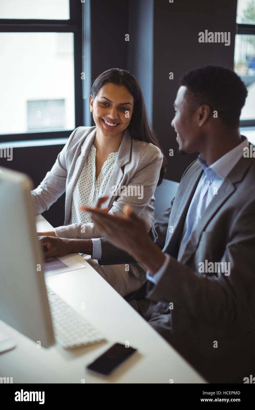 Businessman and a colleague working over computer Stock Photo - Alamy